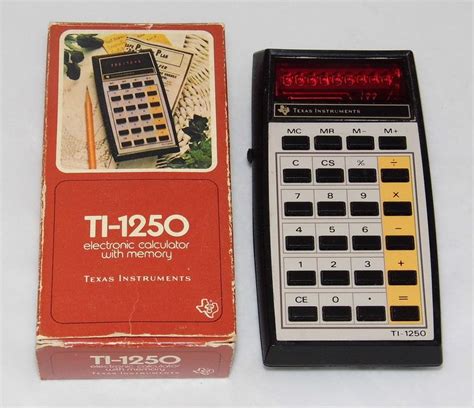 A Calculator Sitting Next To A Boxed Box