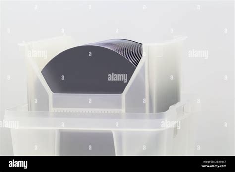 Silicon Wafers In White Plastic Holder Box On A Table A Wafer Is A Thin Slice Of Semiconductor