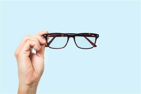 Premium Photo A Hand Holding A Pair Of Glasses That Says A Vision