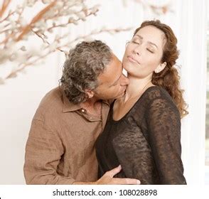 Mature Couple Kissing While Lounging Home Stockfoto 108028898