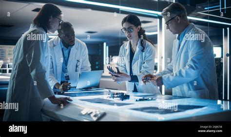 Team Of Tech Scientists Having A Group Meeting In A Research And Development Facility At A Robot