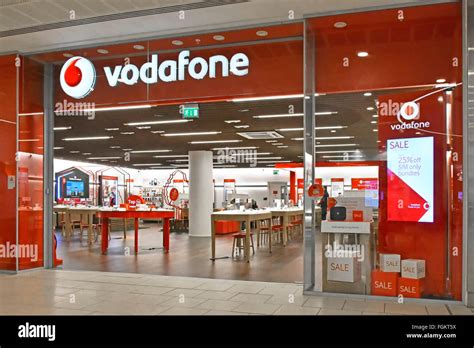Vodafone mobile phone store shopfront sign with interior view of Stock ...