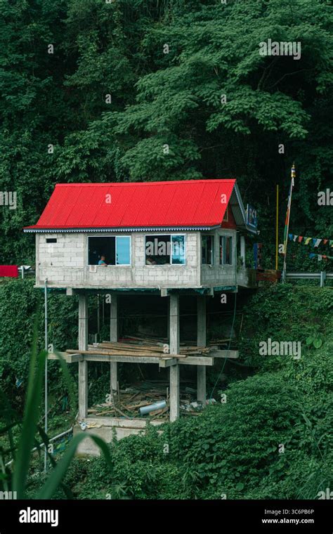 Colorful Red Roofed Houses On A Lush Green Hillside In A Remote