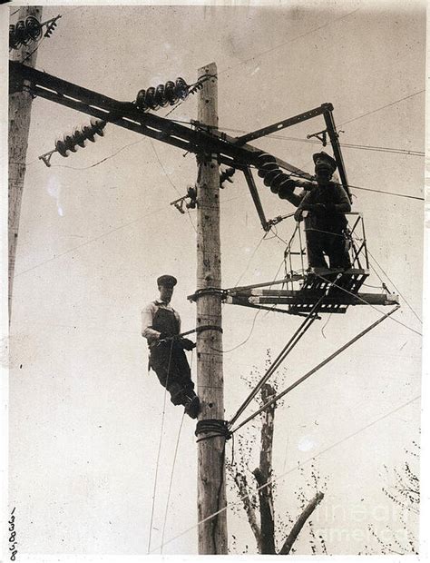 Electrical Line Workers On Pole Platform Art Print By Bettmann