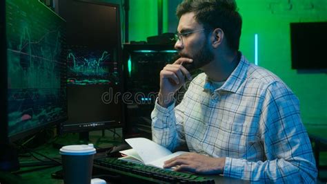 Indian Arabian Man Looking Monitor Computer Chart Graph Trading Online Typing Pc Writing Notes