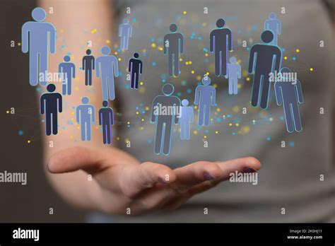 D Floating People Icons Over A Hand A Concept Of Networking HR Communication Stock Photo