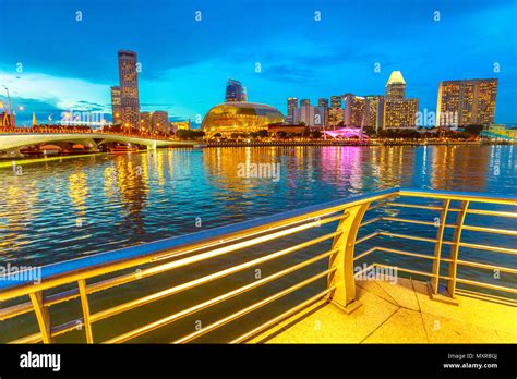 Skyline Of Marina Bay With A Bridge With Evening Lights Reflecting In