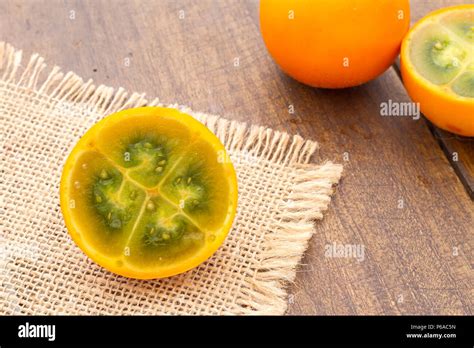 Fruits And Slices Of Lulo Or Naranjilla On The Wooden Table Solanum