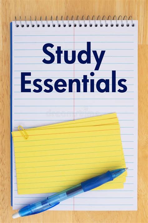 Study Essentials With Spiral Notebook Yellow Index Cards And Blue Pen On Wood Desk Stock Photo