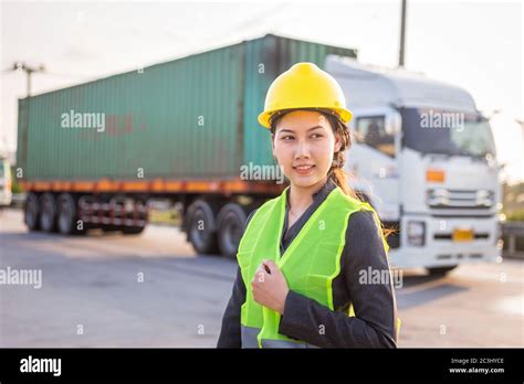 Asian Woman Engineer Check For Control Loading Containers Box From Cargo Freight Ship For Import