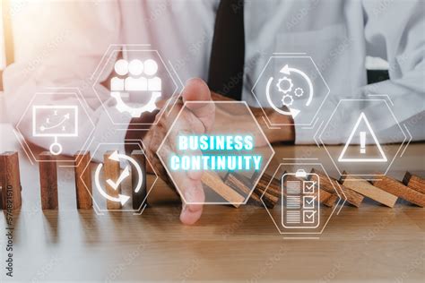 business continuity concept business person hand stopping falling