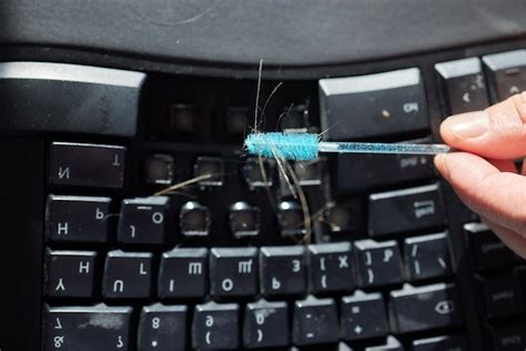 Premium Photo Male Hand Cleans Dirty Keyboard Without Keys With A Brush