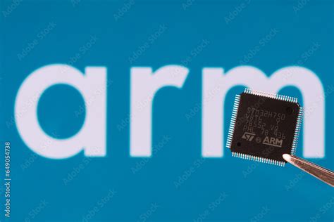 Arm Logo Seen On Stm32 Microchip Hold In Tweezers And Blurred Arm