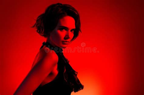 Fashion Portrait Of Stunning Sexual Girl In Red Neon Color Lights On Dark Background Stock Photo