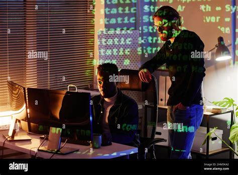 Two Young Intercultural Program Developers Looking At Computer Screen
