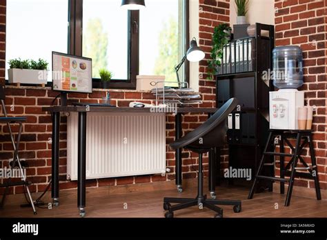 Brick Wall Room Having No People With Computer On Desk Showing Financial Charts Modern
