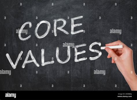Woman Writing Phrase CORE VALUES On Blackboard Closeup Stock Photo Alamy