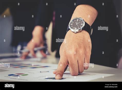 Hands Pointing On Data Chart Sheet For Business Meeting Stock Photo Alamy