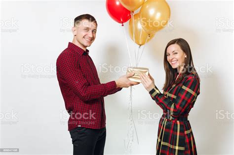 아름 다운 젊은 행복 미소 커플 사랑에 여자와 남자와 황금 선물 상자를 들고 제시 하 고 빨강 노랑 흰색 바탕에 생일 축 하