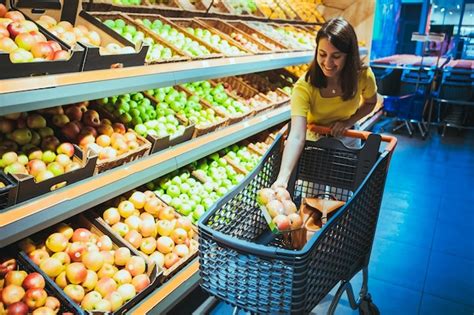 Premium Photo Young Pretty Adult Woman Do Shopping In Grocery Store Buying Apple