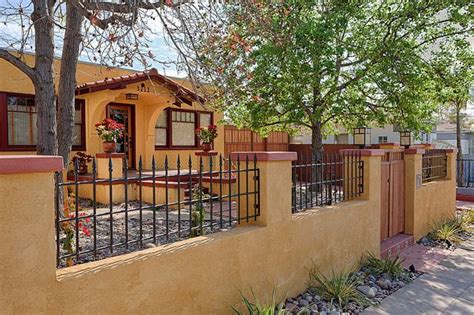 Hacienda Style Home With Vibrant Colors And Iron Fence Spanish Fence
