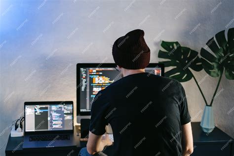 Premium Photo Young Man Mobile Developer Writes Program Code On A Computer Programmer Work In