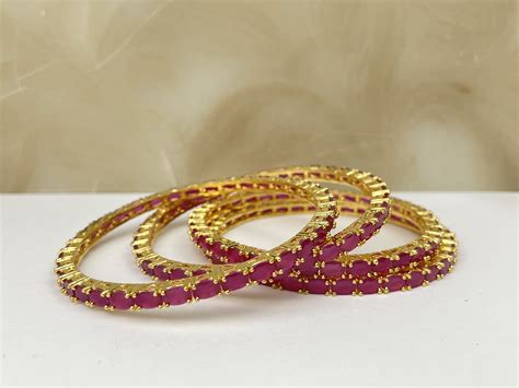 American Diamond Thin Elongated Gold And Ruby Churi Set Chohans Jewellery