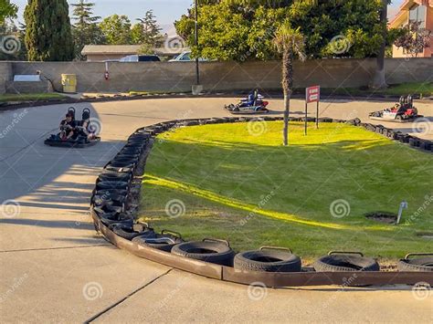Go Kart Drivers Navigate A Winding Track Lined With Tires Editorial Photo Image Of Summer