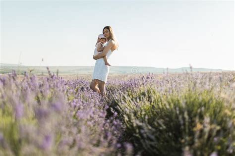 Happy Mom Holds Her Daughter In Her Arms Smiles And Rejoices Stock