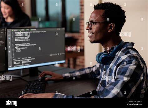 Smiling Confident African American Software Engineer Developing Machine Learning Algorithm In