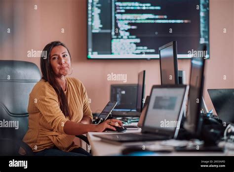 A Businesswoman Sitting In A Programmers Office Surrounded By