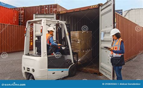 Forklift Driver Loading A Shipping Cargo Container With A Full Pallet With Boxes In Logistics