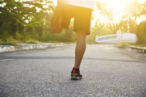 Premium Photo Low Section Of Man Running On Road