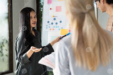 Creative Team Collaborating On Ux Ui Design Project With Wireframes And Color Swatches In Modern