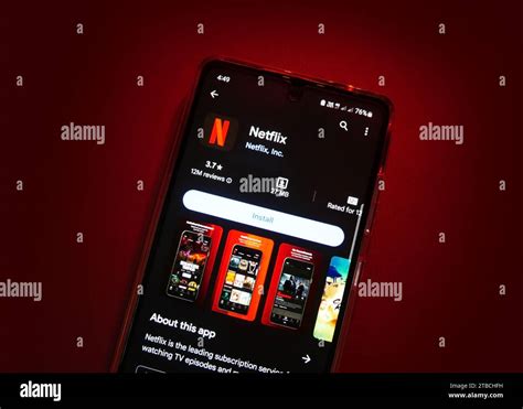 Hand Holding A Phone With Netflix Application On Playstore On