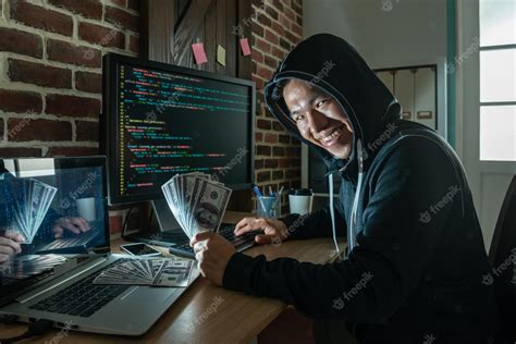 premium photo hacker looking round and holding banknote smiling with