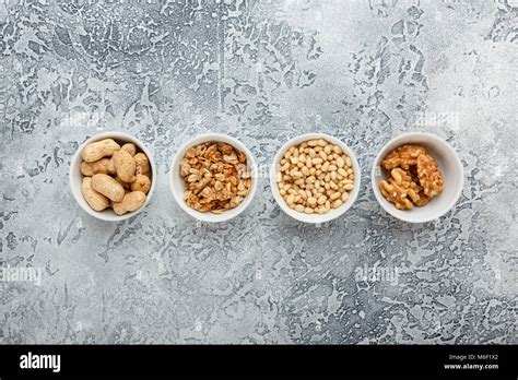 Set Of Different Types Of Nuts Peanuts In Shells Pine Nuts On Gray Background Stock Photo Alamy