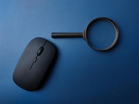 Premium Photo Closeup Magnifying Glass And Wireless Mouse On A Blue