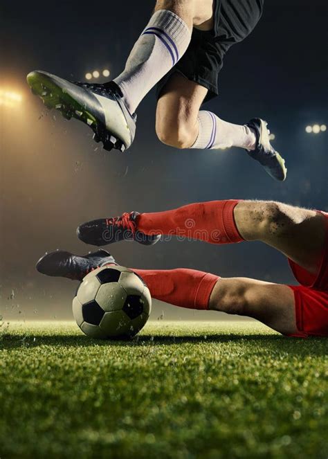 Football Sliding Tackle Moment With Airborne Legs And Ball On Night