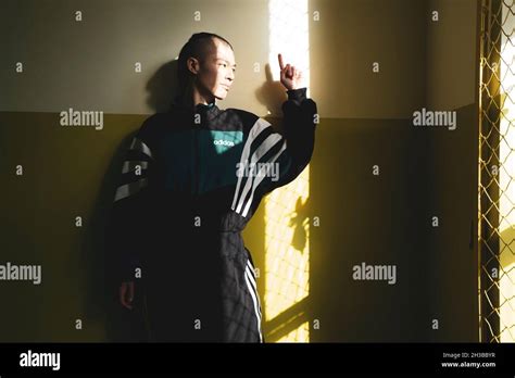 Athletic Androgynous Strong Woman Stand In Shadow And Window Sunlight