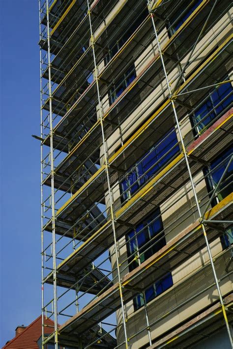 Scaffolding Structure On A Modern Building Under Renovation With Metal
