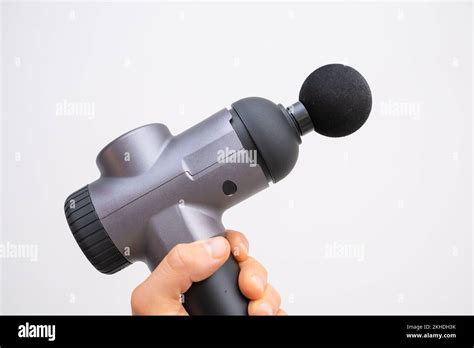 Electric Massager Gun In Mans Hand On The White Background Recovery