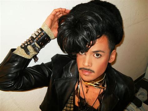 Premium Photo Portrait Of Young Man Wearing Wig And Make Up Against Wall