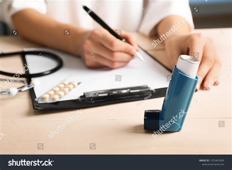 Doctor Writing Out Prescription Using Inhaler Stock Photo 1323467699 Shutterstock