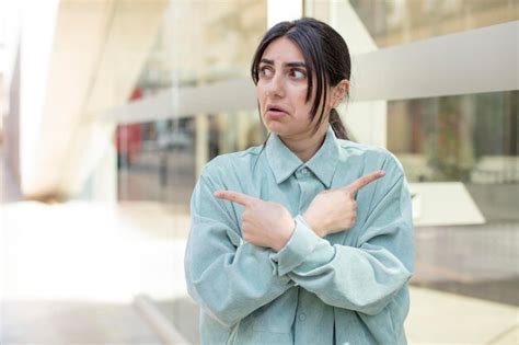 Premium Photo Looking Puzzled And Confused Insecure And Pointing In Opposite Directions With