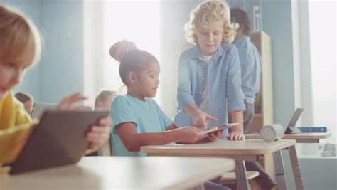 Elementary School Computer Science Class Smart Girl Uses Digital Tablet Computer Her Classmate