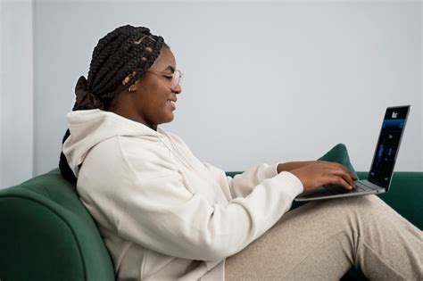 Free Photo Side View Woman With Laptop On Couch