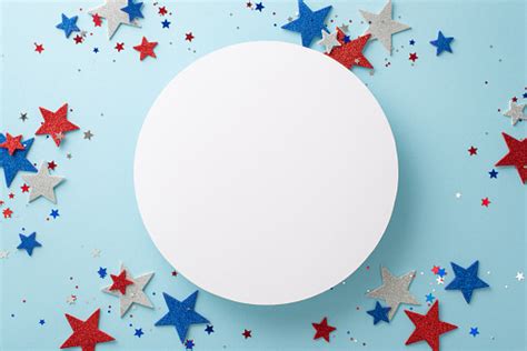 상징적 인 파티 필수품의 상단보기로 독립 기념일의 정신을 축하하십시오 상단보기 반짝이는 별 반짝이는 색종이 조각 등 파스텔 블루 배경에는 텍스트 또는 광고를 위한 빈 원이