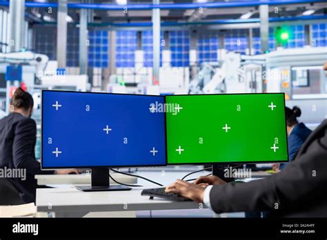 Solar Panels Plant Engineer Overseeing Energy Consumption Using Isolated Screen Pc