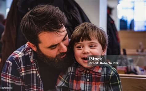 Happy And Smiling Nephew Sitting On His Uncle S Lap Having Fun Moments